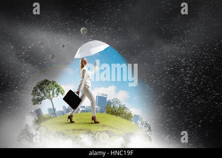 Elegant businesswoman hiding from rain under umbrella Stock Photo - Alamy