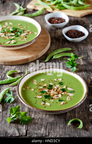 Homemade olive oil with herbs and spices in a small bottle on a wooden ...