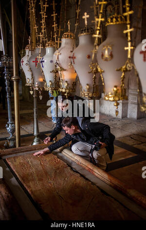 Man praying,Stone of Unction, Church of the Holy Sepulchre also called ...
