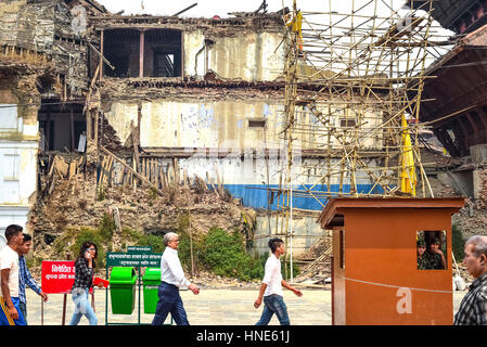 People walk near a destroyed building in the eastern Ghouta of Damascus ...