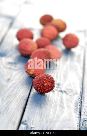 Lychees cut fruit over wooden table Stock Photo - Alamy