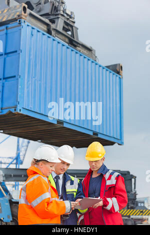 Caucasian woman standing over blue background pointing with finger ...