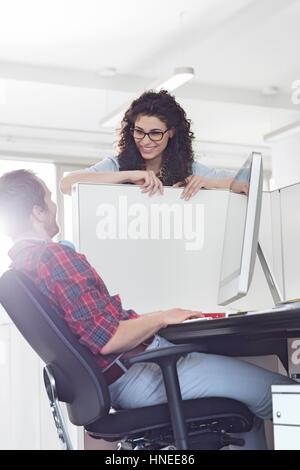 Business people talking over cubicle wall Stock Photo - Alamy