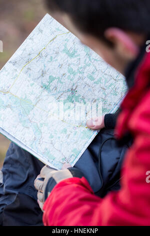 Hiker reading a map Stock Photo - Alamy