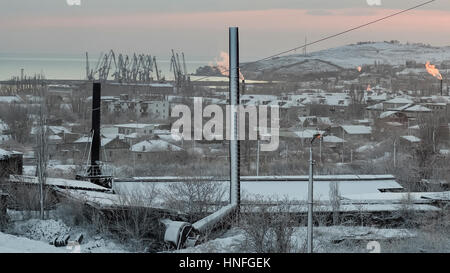 The rising sun, snow city and factory Stock Photo - Alamy