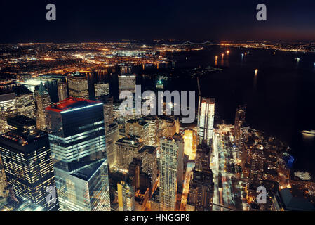 Rooftop night view of New York City downtown with urban skyscrapers ...