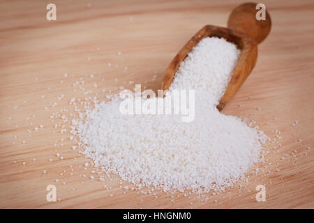 Granulated cassava (tapioca) on wooden background. Selective focus ...