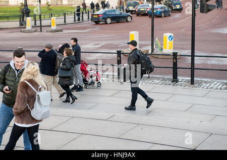 A suspicious looking man with several backpacks takes pictures by ...