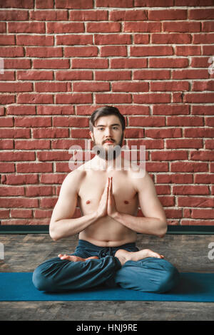 Handsome man doing yoga positions Stock Photo - Alamy