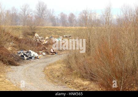Wild garbage dump in nature. Open landfill site. Pile of garbage ...