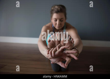 Ashley Cottrell, co-owner of Evolution Yoga, demonstrates yoga poses in ...