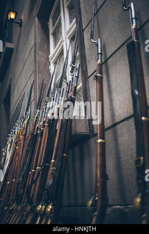 a lot of rifles/muskets leaning at a house wall with a window in Paris ...