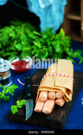 Eating Sausages (Frankfurter) on paper with bread, mustard and ketchup ...