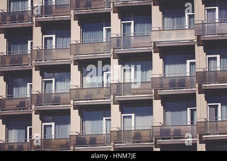 repeating pattern of windows and balcony.Building front white color ...