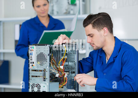 team of students examining and repairing computer parts Stock Photo - Alamy