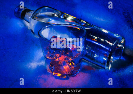 Glasses of Vodka lit with blue backlight. Copy space Stock Photo - Alamy