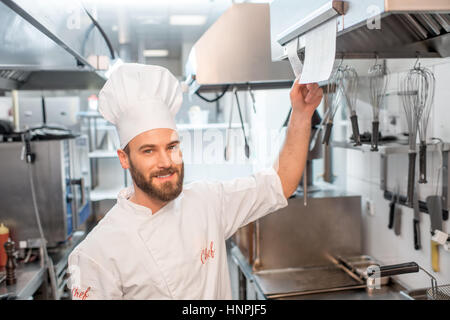 Chef cook checking the order at the restaurant kitchen Stock Photo - Alamy