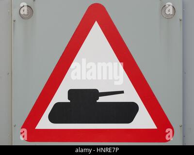 Warning road sign. Tanks crossing and sudden gunfire Stock Photo - Alamy