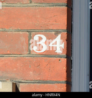 House number 34 sign on ceramic tile with painted flowers Stock Photo ...