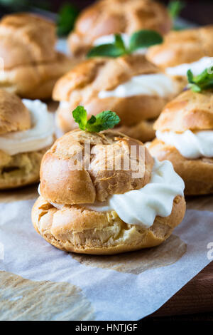 Homemade profiteroles on baking paper isolated on white Stock Photo - Alamy