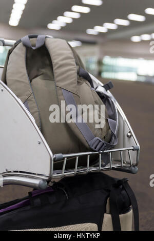 brown rucksack on trolley cart in airport terminal building for travel ...