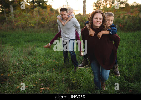 Children giving piggyback, piggy back child carrying sister on her back ...