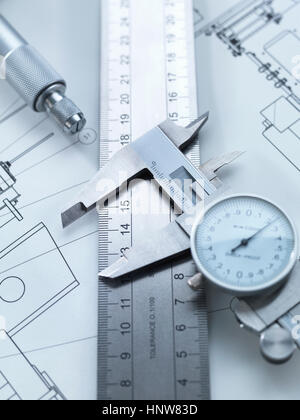 Engineering Measurement, Dial calipers sitting on a steel rule with ...