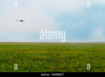 plane flies above the landscape. Side view of aircraft. Travel and ...