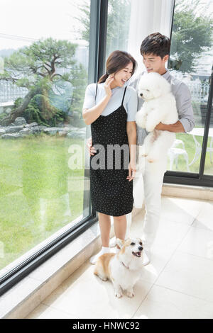 Harmonious couple with pet dogs Stock Photo - Alamy
