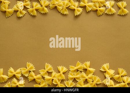 Pasta bow and spiral shape on pink background Stock Photo - Alamy