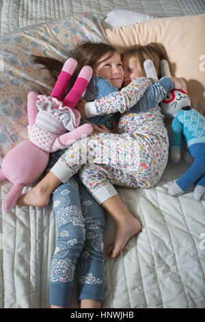 Girl lying on bed with legs crossed at ankle Stock Photo - Alamy