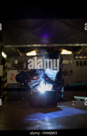 Female metalsmith welding metal box on workbench Stock Photo - Alamy