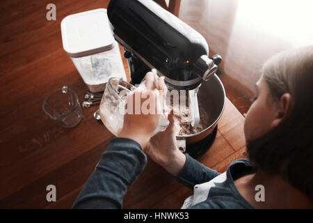 pouring ingredients into a mixer Stock Photo - Alamy