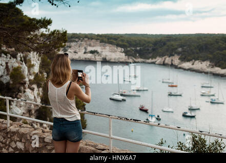 Woman taking photograph with smartphone, Menorca, Spain Stock Photo - Alamy