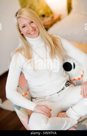 Photo of cheerful pretty person sit behind desktop toothy smile look ...