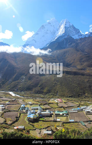 Nepal, Khumbu, Dingboche, Ama Dablam looming over illuminated village ...