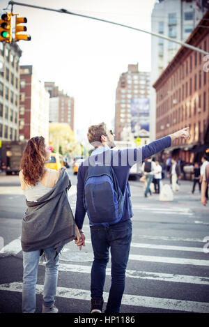 Rear view of excited couple enjoying roller coaster ride at Pacific ...