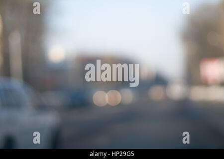 Traffic abstract background with blurry buildings, street signs and ...