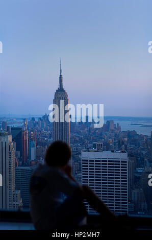 From above positive boy in pajama looking away while lying down on ...