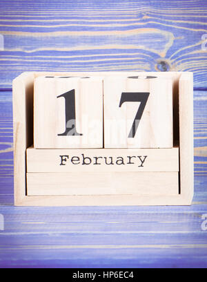 February 17th. February 17 wooden cube calendar with blur objects on ...