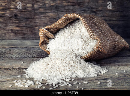 grains of black rice on wooden background Stock Photo - Alamy