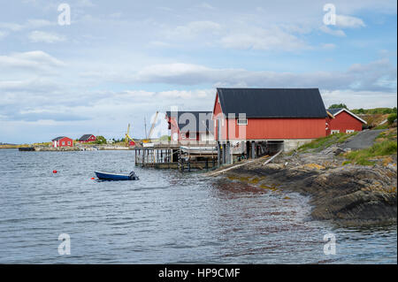 Traditional Norwegian red wooden houses (rorbuer) on the shore of ...