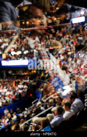 President Donald Trump is reflected in a glass table top as he speaks ...