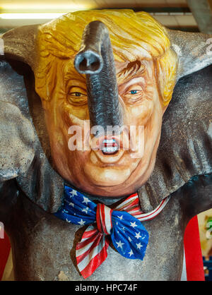 A carnival float shows US president Obama pushing a camel to go through ...