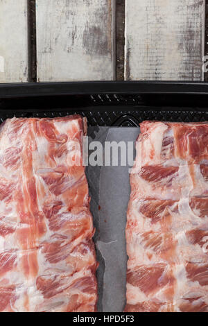 Beef ribs in black box against wooden background Stock Photo - Alamy