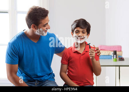 Father and son applying shaving cream Stock Photo - Alamy