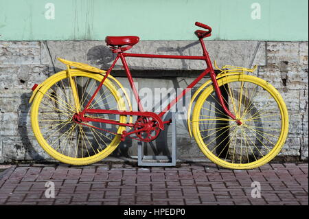 old yellow bicycle stands at the walls the city houses Stock Photo - Alamy