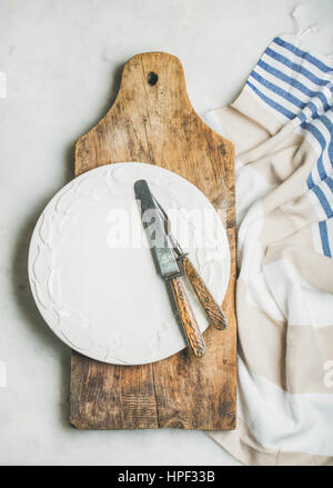 Table setting with white plate, cutlery and eucalyptus Stock Photo - Alamy