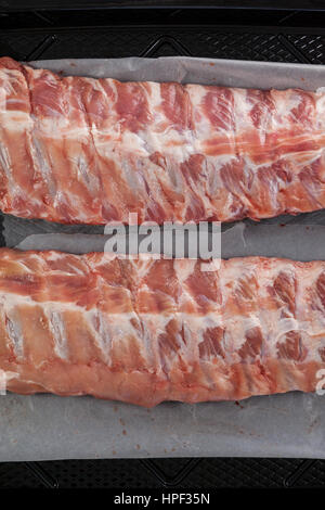 Beef ribs in black box against wooden background Stock Photo - Alamy