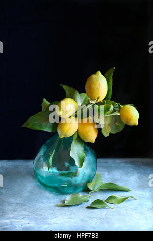 Fresh and ripe lemons with leaves on white wood Stock Photo - Alamy
